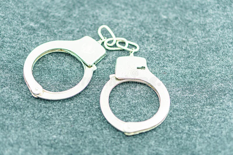 Handcuffs on an Empty Background, Photography. Police Handcuffs on Dark ...