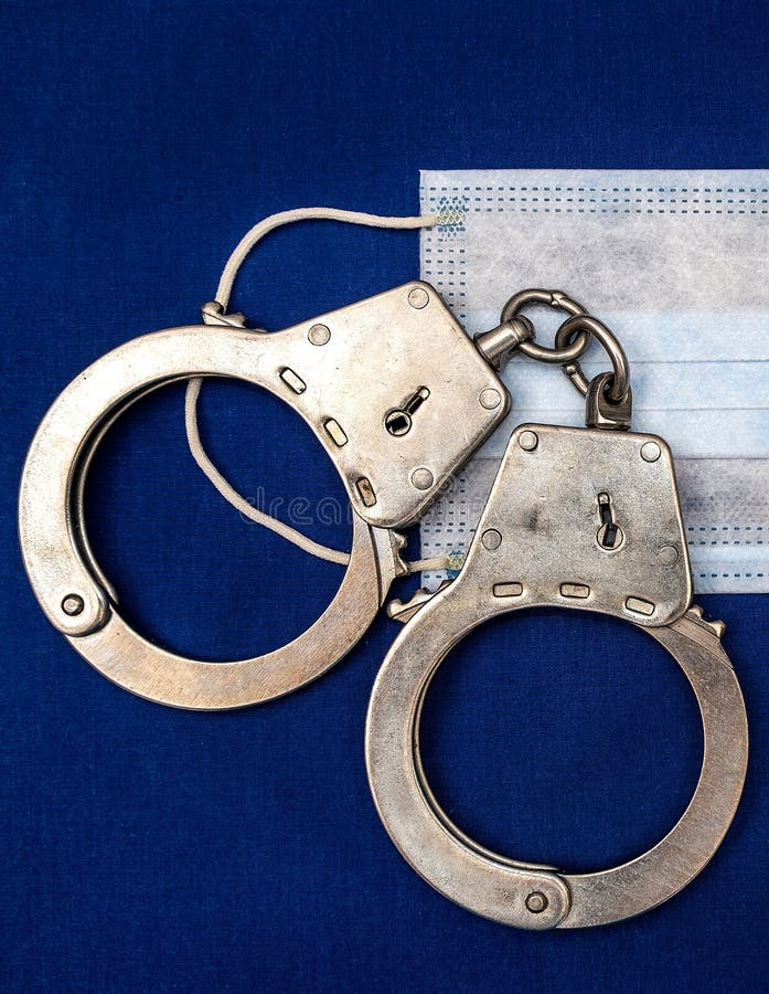 Handcuffs and Flu Mask stock photo. Image of crime, care - 230659766