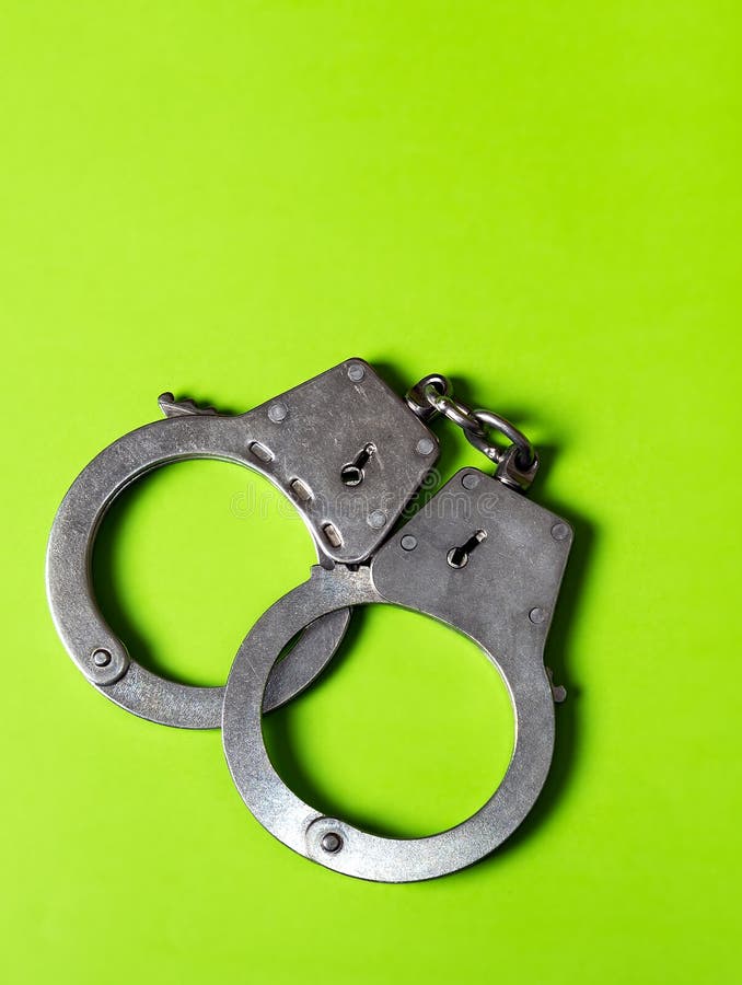 Handcuffs on the Green Background Stock Image - Image of prison, metal ...