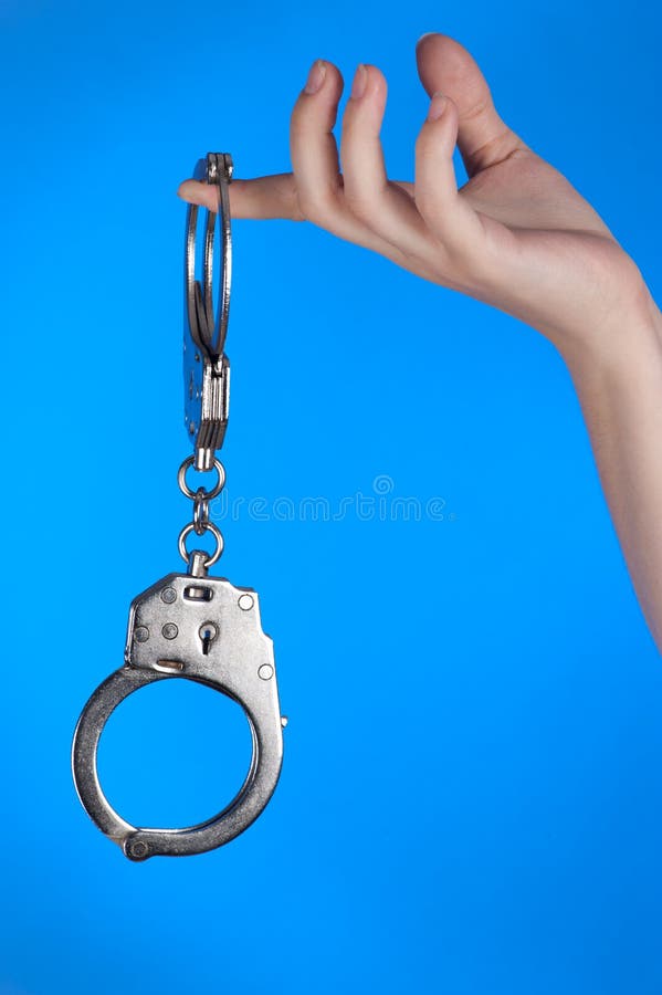 Handcuffs in hand stock photo. Image of crime, cheat - 22062644