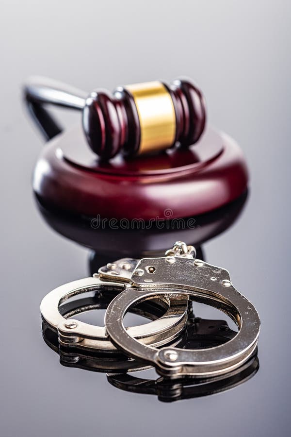 Handcuffs and Judge Gavel on Mirror Table Stock Photo - Image of ...