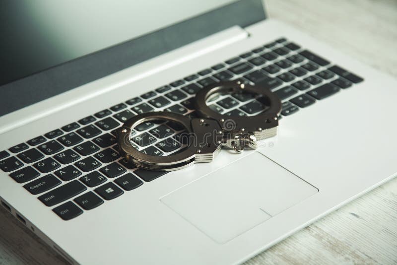 Handcuffs on keyboard stock image. Image of corporate - 135789039