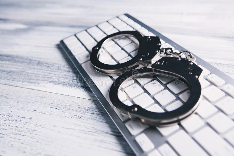 Handcuffs on the keyboard stock image. Image of hacker - 235699719
