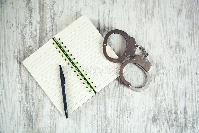 Handcuffs on notrpad stock photo. Image of equality - 136194314