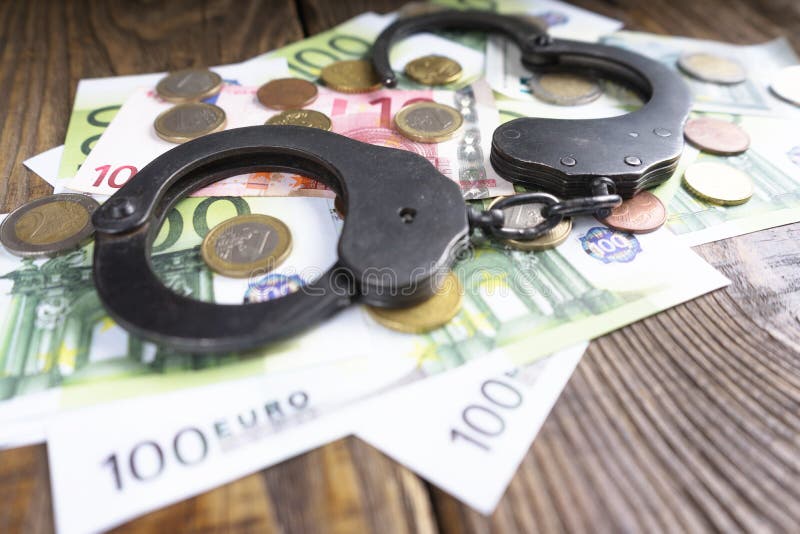 Handcuffs on a Pile of Euro Banknotes. the Symbolic Meaning of Economic ... Handcuffs on a Pile of Euro Banknotes. the Symbolic Meaning of Economic ...