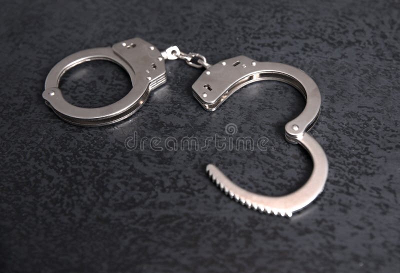 Handcuffs on table stock image. Image of wooden, bracelet - 193055417