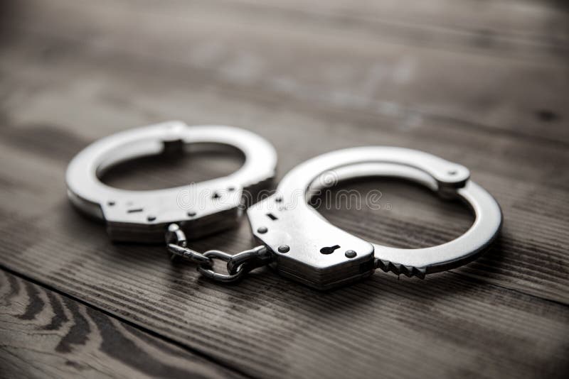 Handcuffs on table stock photo. Image of iron, closed - 195252102