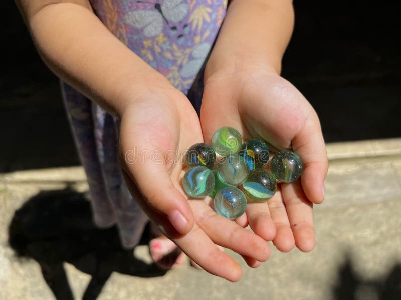 A Handful of Colorful Marbles Stock Photo - Image of colorful, crystal ...