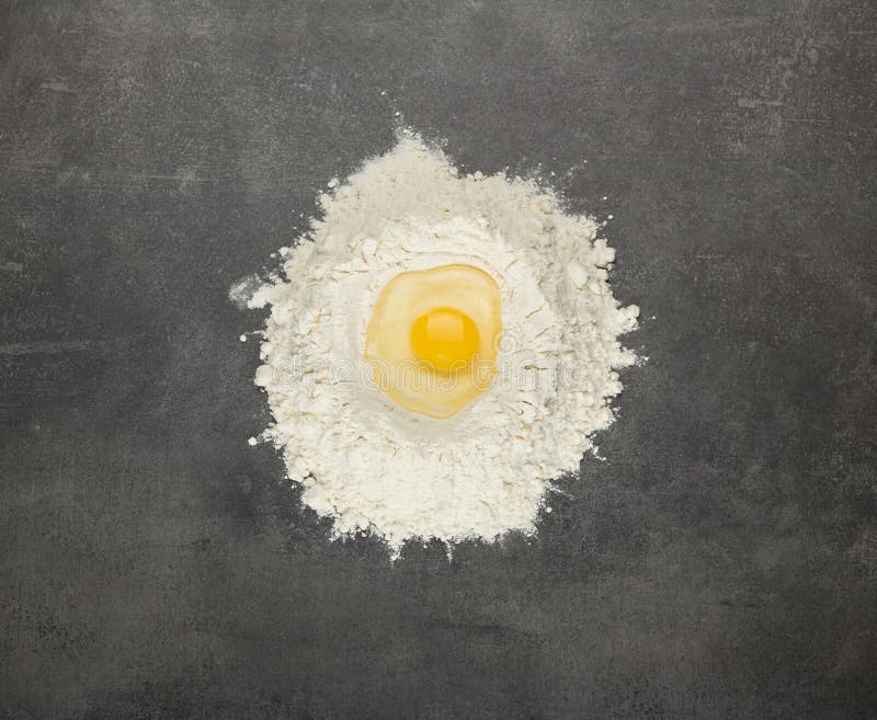 Handful of Flour, Egg on Top, on Work Surface Stock Photo - Image of ...