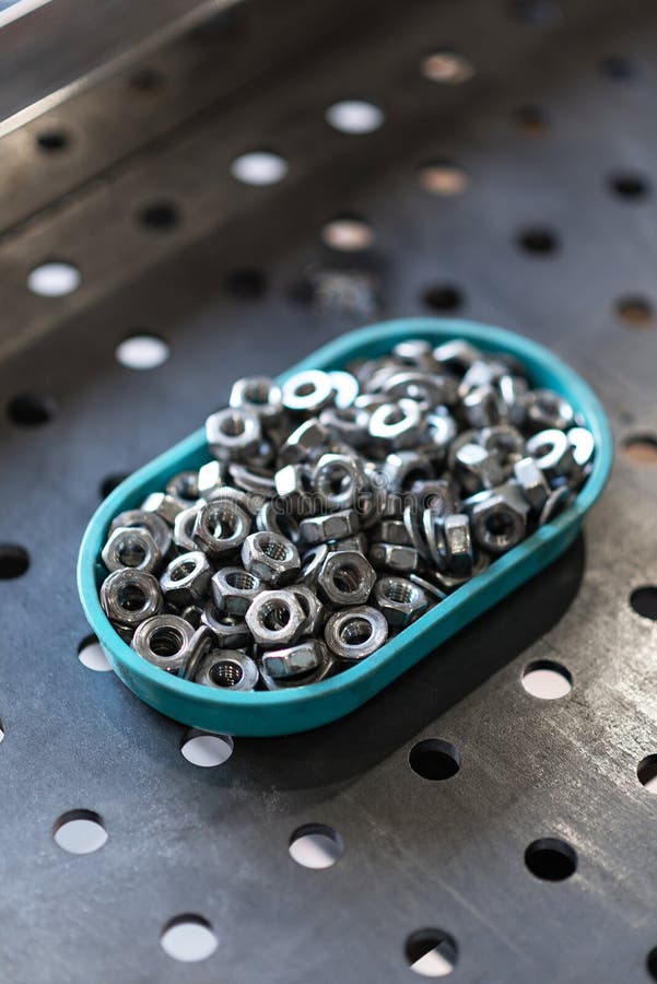 A Handful of Metal Nuts in a Plastic Container for Storage Stock Photo ...