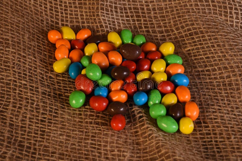 A Handful of Multi-colored Sweets on a Rough Fabric Stock Image - Image ...