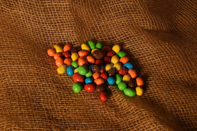 A Handful of Multi-colored Sweets on a Rough Fabric Stock Photo - Image ...