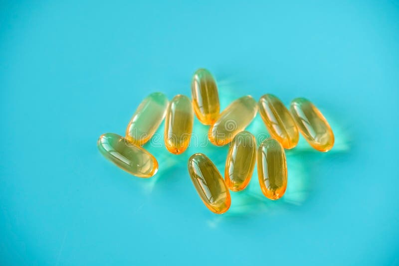 Handful of Omega 3 Capsules on a Blue Background . Stock Photo - Image ...