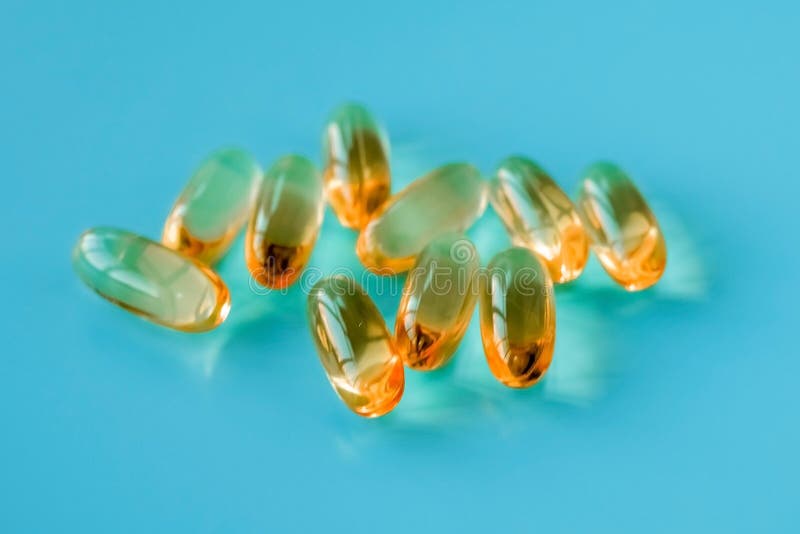 Handful of Omega 3 Capsules on a Blue Background Stock Image - Image of ...