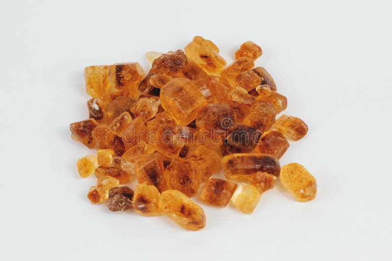A Handful of Cane Sugar in Solid Slices of Orange Crystals on a White ...