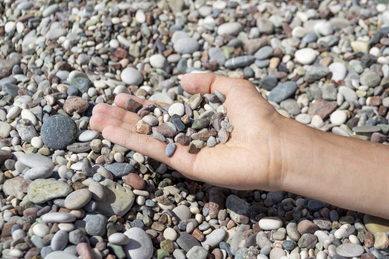 Pebbles in fingers stock image. Image of beach, pattern - 34110299