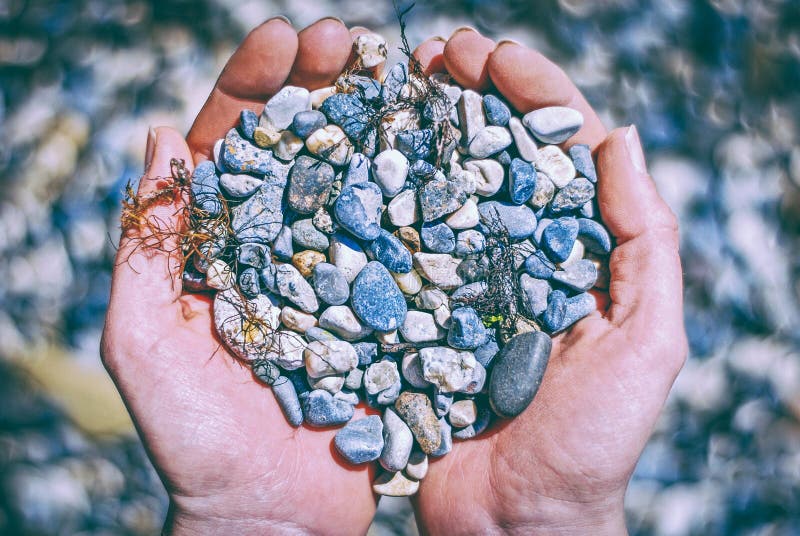 Handful of stones in hands stock image. Image of boulder - 66600061