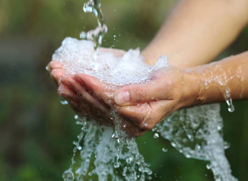 Water Pouring in Human Hand on Nature, Environment Issue Stock Image ...