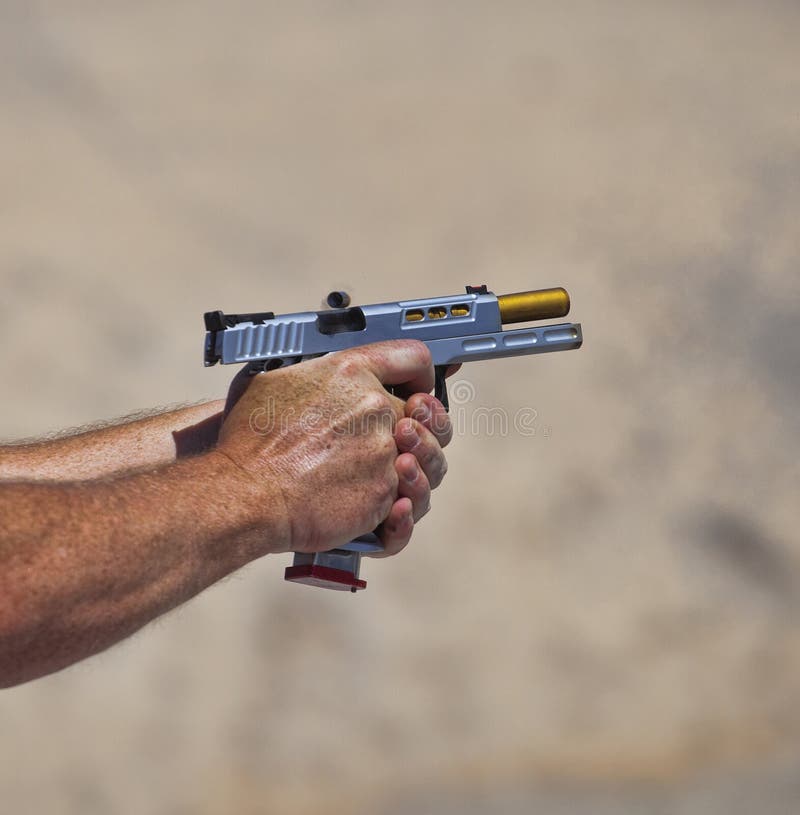 Brass leaving a pistol stock photo. Image of hands, control - 102797552