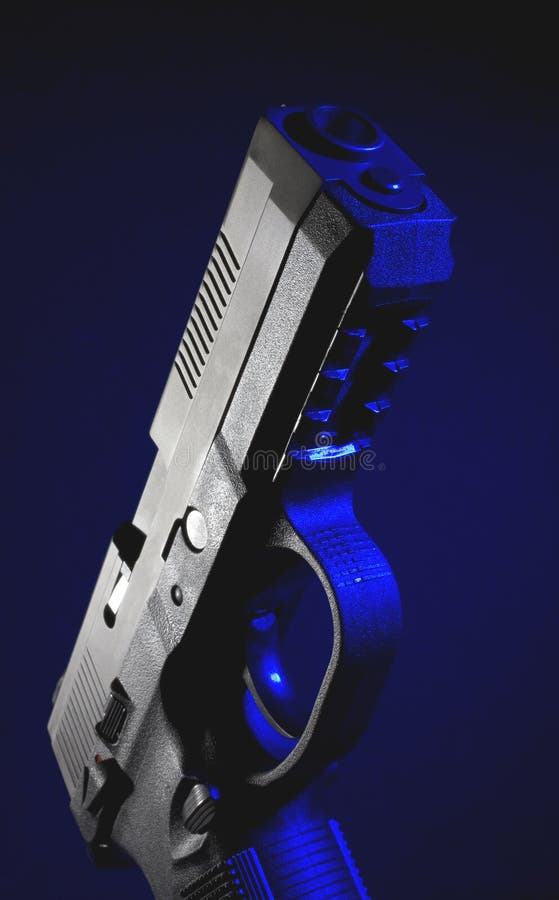 Handgun with a blue gel stock photo. Image of reflection - 15571662