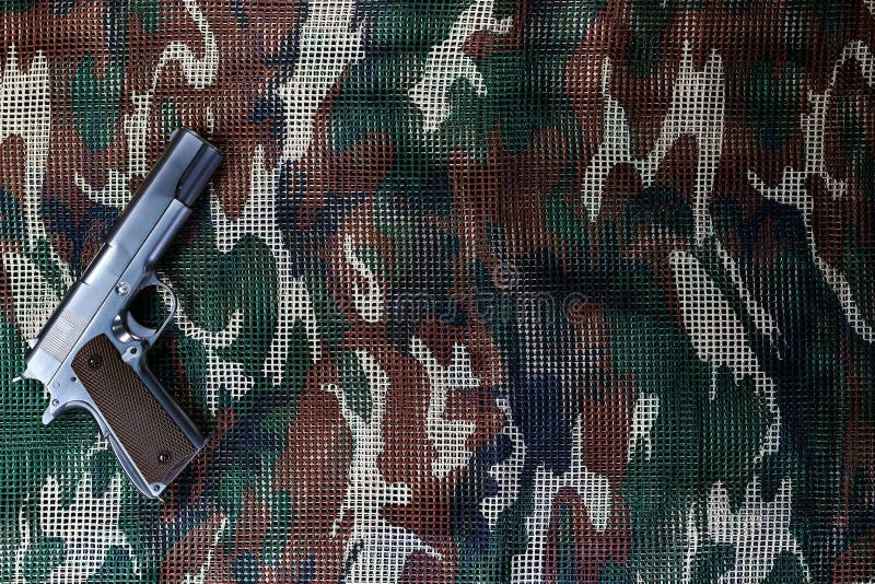 Handgun on Military Camouflage Net Background Stock Photo - Image of ...