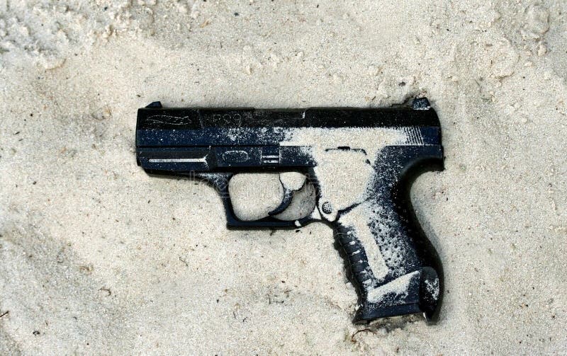 Handgun in sand stock photo. Image of beige, sand, barrel - 6762106
