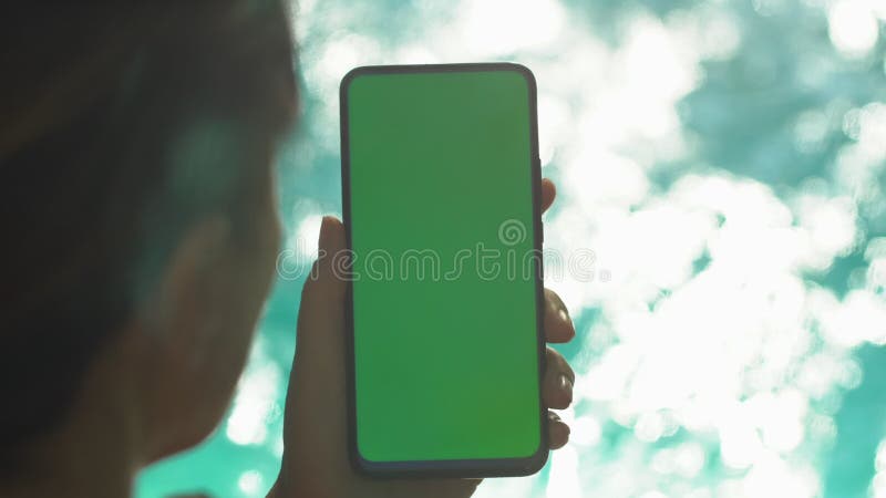 Handheld Camera: Back View of Brunette Holding Chroma Key Green Screen ...