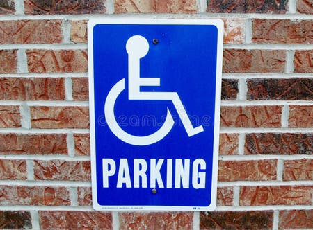 Handicap Parking Sign on Brick Wall Stock Photo - Image of ...