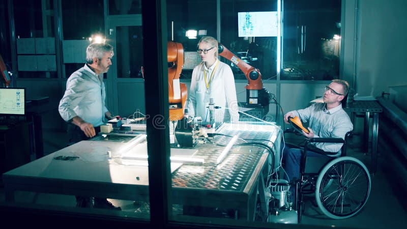 Disabled Engineer with Colleagues are Discussing Robots Stock Footage ...