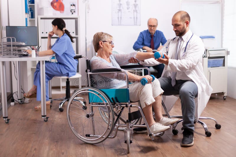 Handicapped Patient Getting Help from Physical Therapist Stock Photo ...