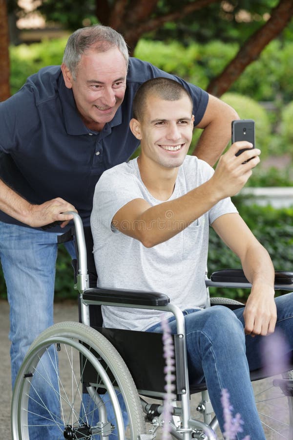 Handicapped Son on Wheelchair Taking Selfie with Dad Stock Image ...