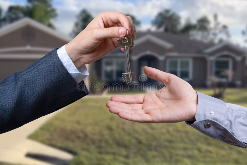 Handing Over the House Keys in Front of a Beautiful New Home. Stock ...