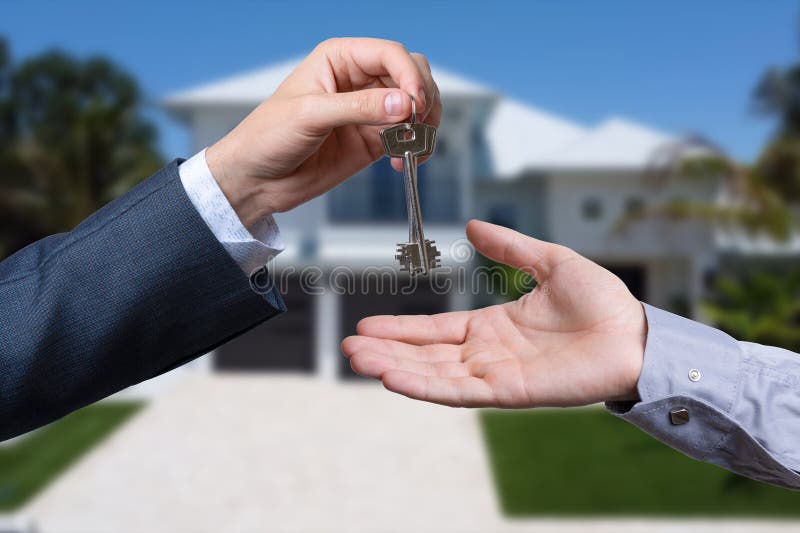 Handing Over the House Keys in Front of a Beautiful New Home. Stock ...