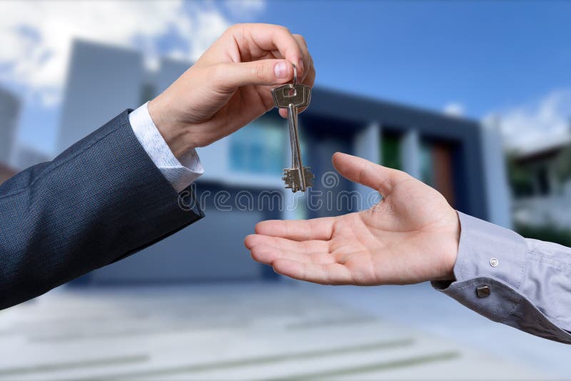 Handing Over the House Keys in Front of a Beautiful New Home. Stock ...