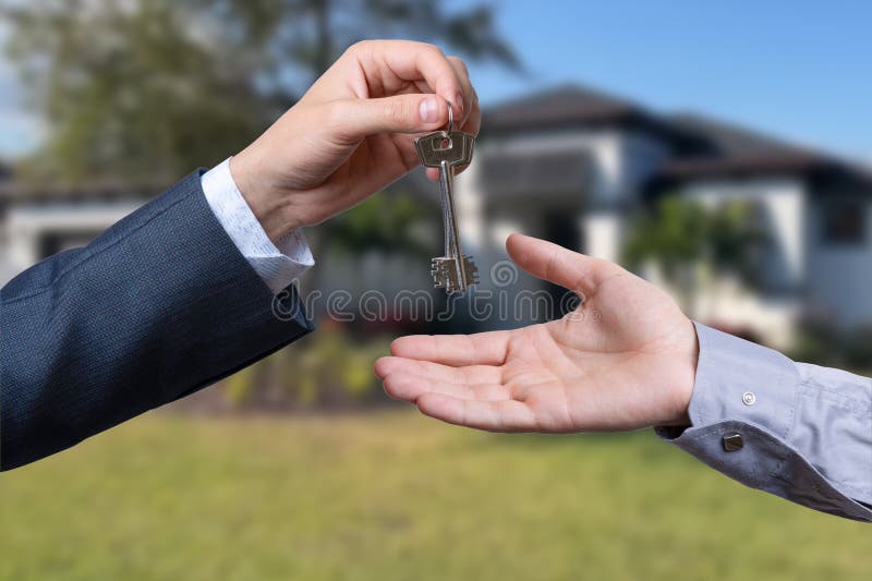 Handing Over the House Keys in Front of a Beautiful New Home. Stock ...