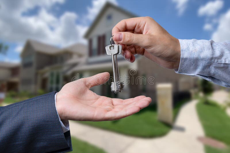 Handing Over the House Keys in Front of a Beautiful New Home. Stock ...