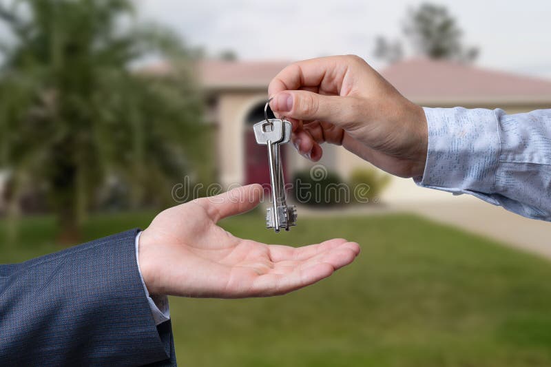 Handing Over the House Keys in Front of a Beautiful New Home. Stock ...
