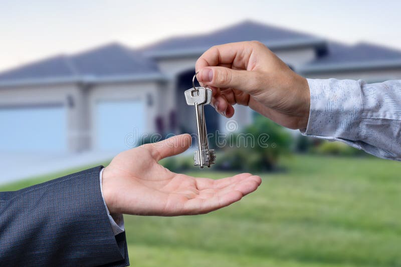 Handing Over the House Keys in Front of a Beautiful New Home. Stock ...