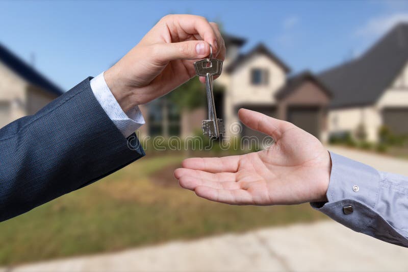 Handing Over the House Keys in Front of a Beautiful New Home. Stock ...