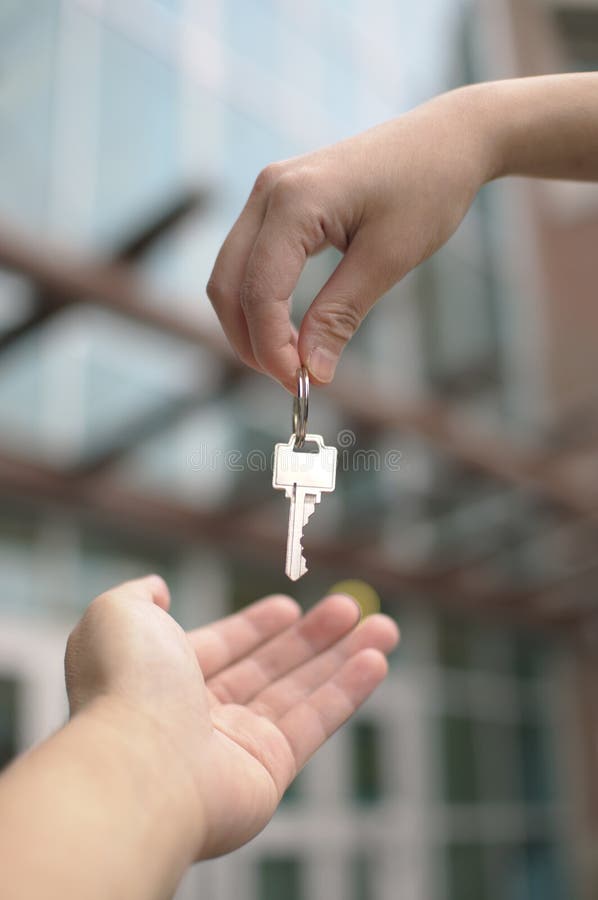 Handing Over the Key stock photo. Image of property, keychain - 21892828