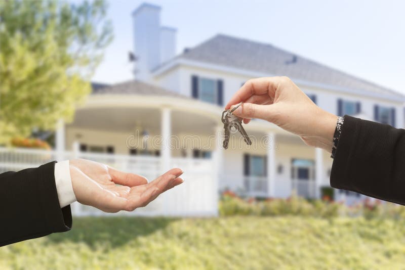Realtor Handing Over the House Keys in Front of New Home Stock Photo ...