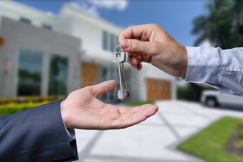 Handing Over the New House Keys with Home in the Background. Stock ...