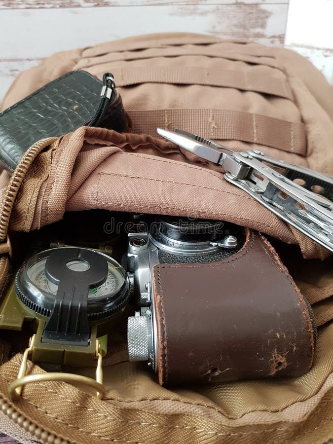 Film Camera Compass and Multitool in the Backpack Stock Photo - Image ...
