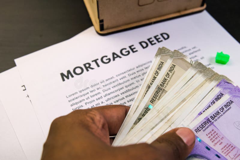 Handling Mortgage Deed and Currency Notes on a Desk Stock Photo - Image ...