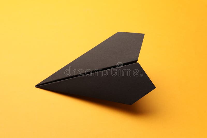 Handmade Black Paper Plane on Yellow Background Stock Photo - Image of ...