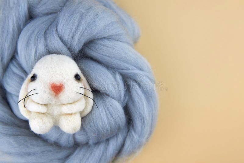 Handmade Bunny Felted of Wool on a Beige Background Stock Photo - Image ...