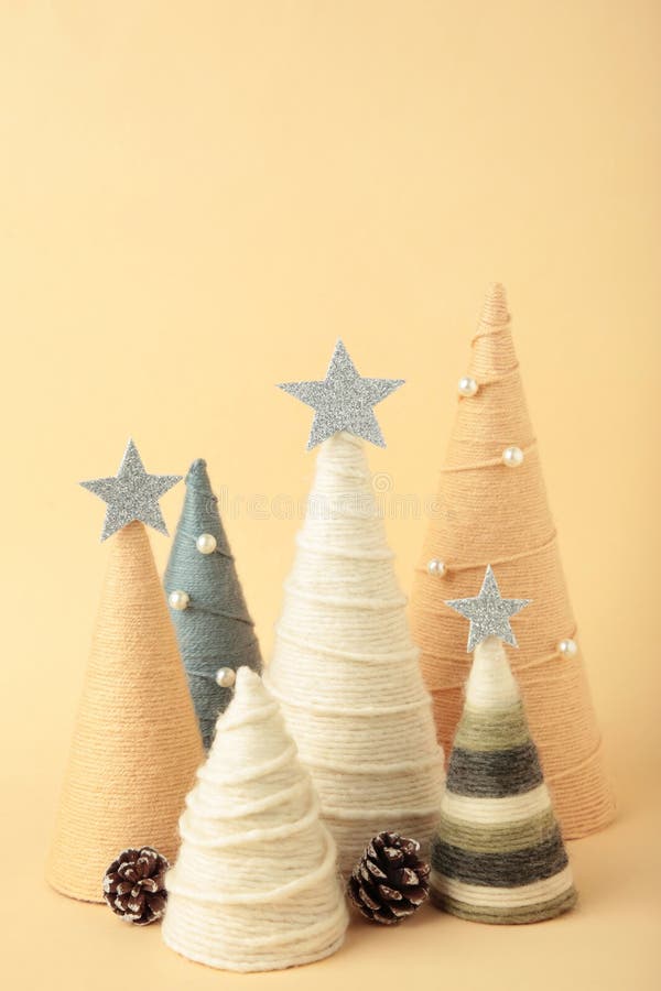 Handmade Christmas Trees on Beige Background. Yarn Wrapped Cone Trees ...