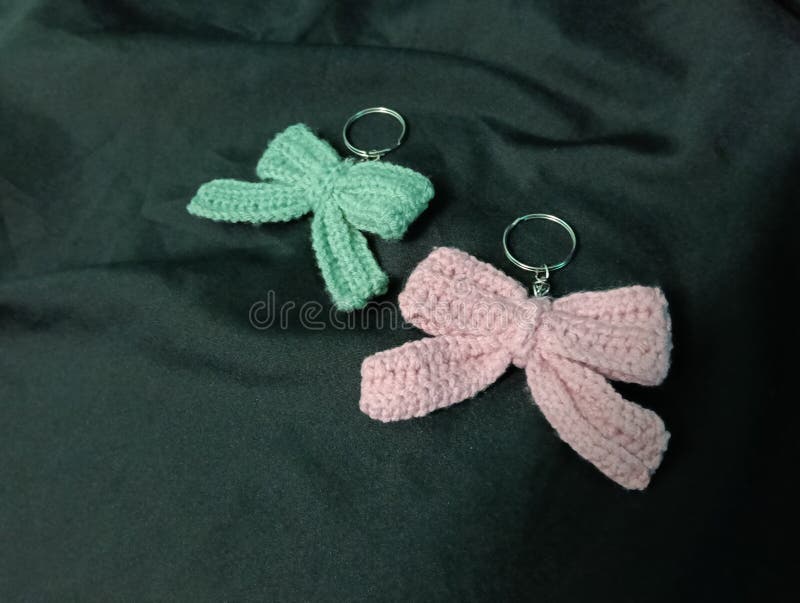 Handmade Crochet Keychains with Bow Designs on Dark Fabric Background ...