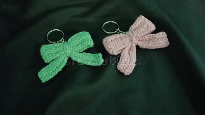 Handmade Crochet Keychains with Bow Designs on Dark Fabric Background ...
