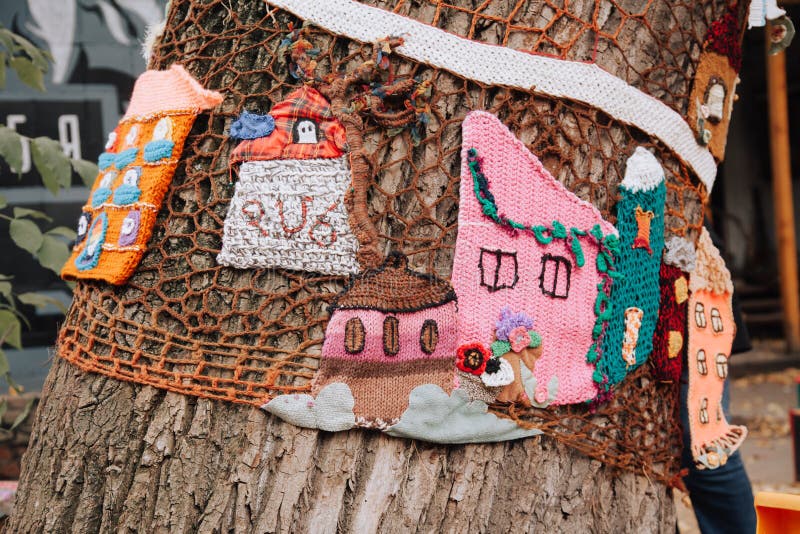 Handmade Decoration of Knitted Houses Around the Tree Trunk Over the ...